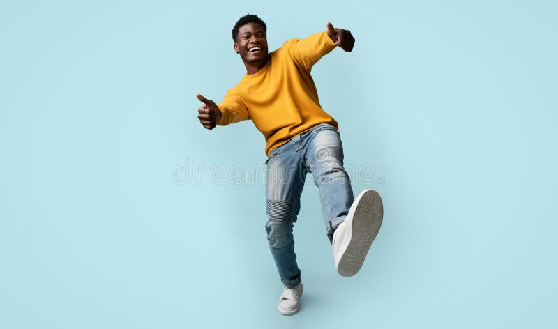 Carefree African American Man Showing Thumb Ups On Blue Stock Image