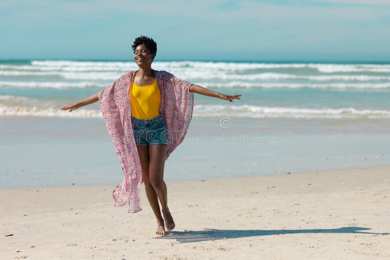 Carefree African American Young Woman Wearing Sarong Jacket With Arms