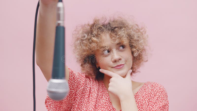 Carefree Girl Holding A Microphone With Its Wire The Mic Is Hanging Upside Down Stock Image