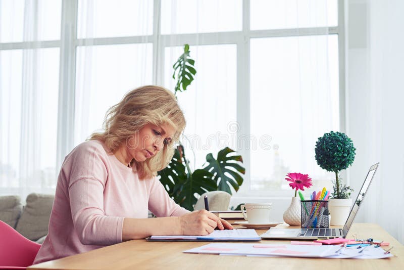 Careful Blonde Drinking Coffee while Writing Stock Photo - Image of ...