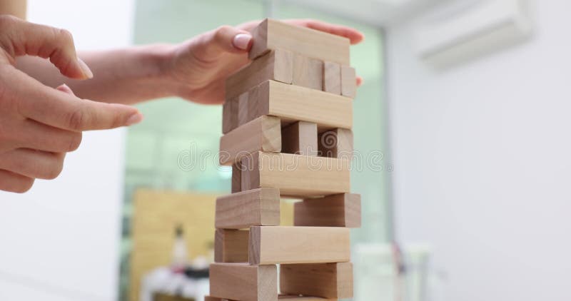 Careful Construction of Wooden Tower in Simple Workspace Stock Footage ...