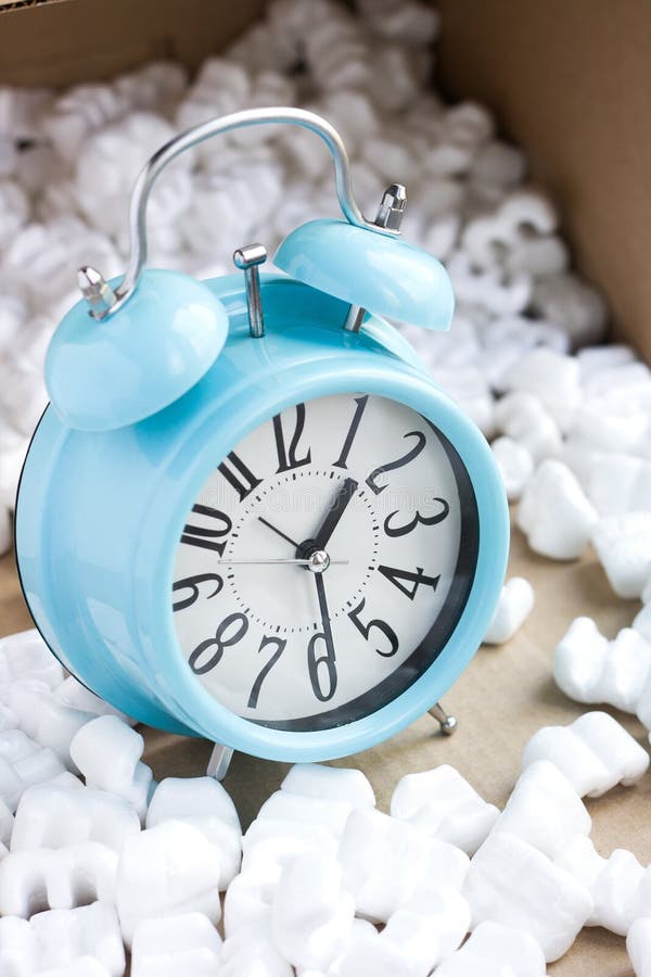 Careful Delivery on Time. Blue Clock Against Card Box with Styrofoam ...