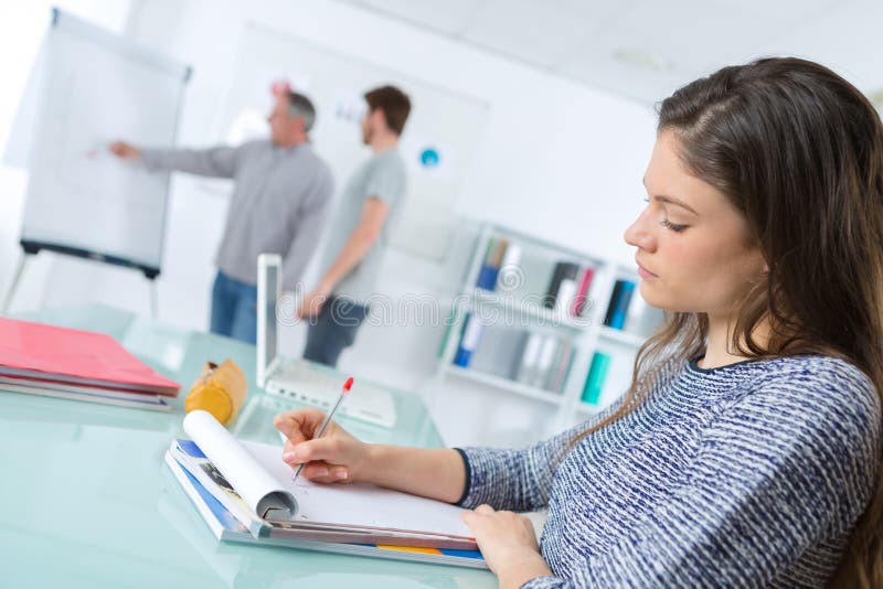 Careful Female Student Taking Notes in Class Stock Image - Image of ...