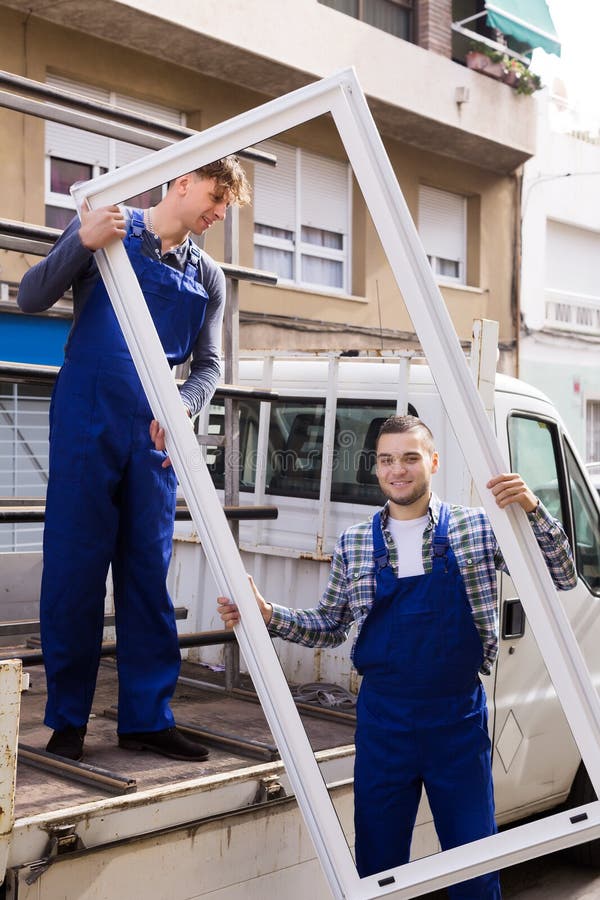 Workmen Carrying Windows Frames at Factory Stock Image - Image of ...