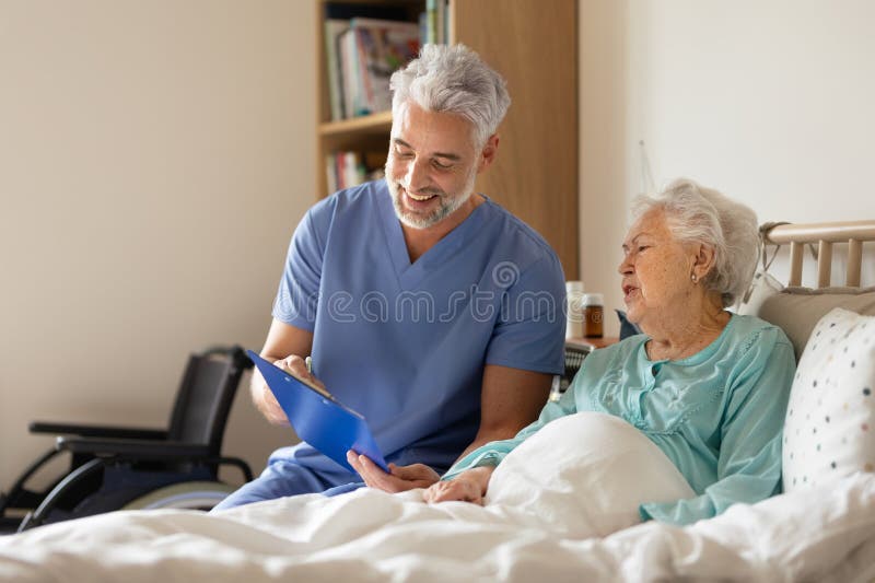 Caregiver Doing Regular Check-up of Senior Woman in Her Home. Stock ...