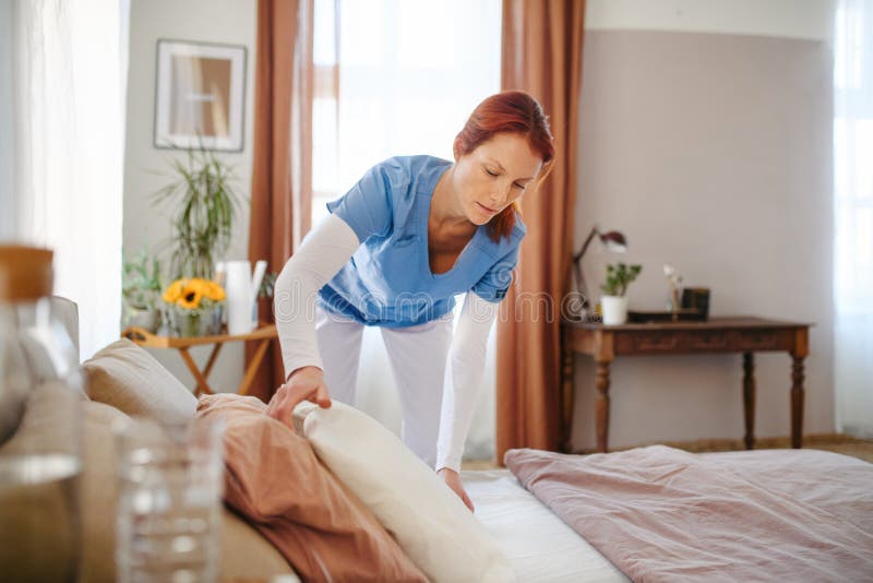 Caregiver Making the Bed at Clients Home. Stock Image - Image of ...