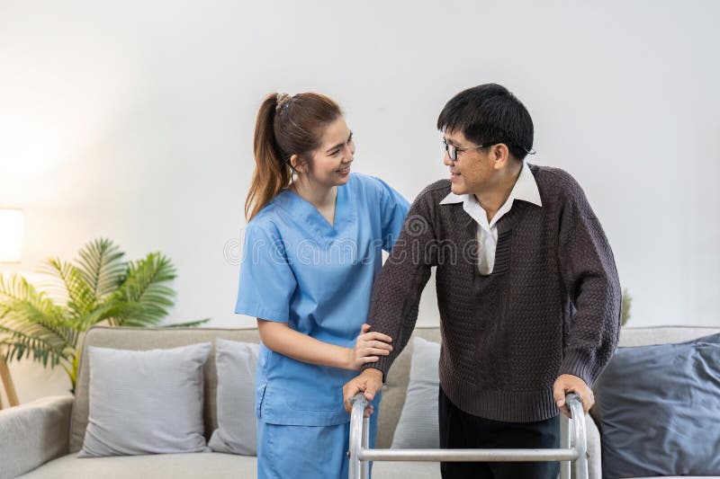 Caregiver or Nurse Help Support Elderly are Standing Up with Walker at ...