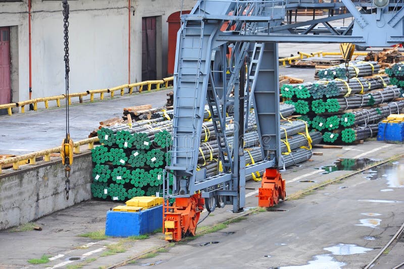 Cargo crane and pipe stack stock image. Image of machinery - 67598625