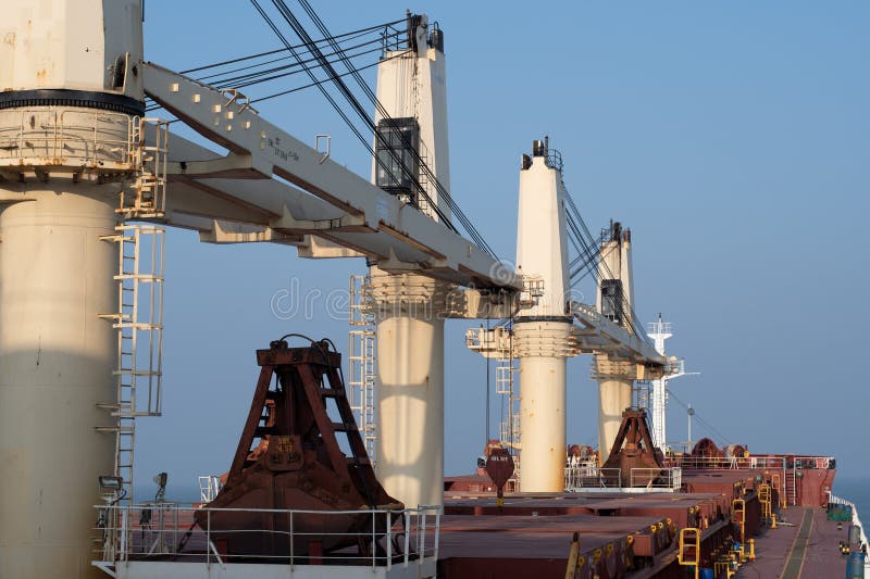 Cargo Handling Cranes, Grabs of a Bulk Carrier Stock Image - Image of ...