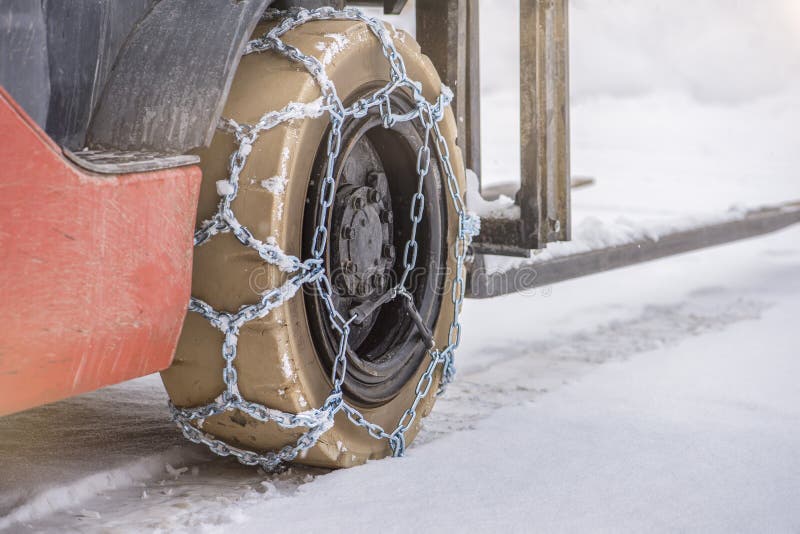 Cargo Loader in Winter on Snow. the Loader Ride on Snow with Chains on ...
