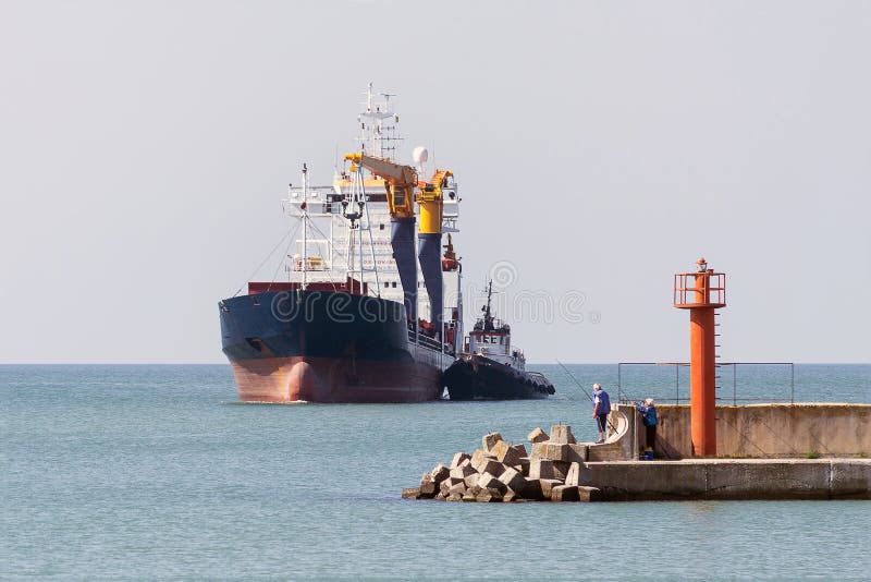 Cargo ship entering harbor editorial stock photo. Image of balcic ...