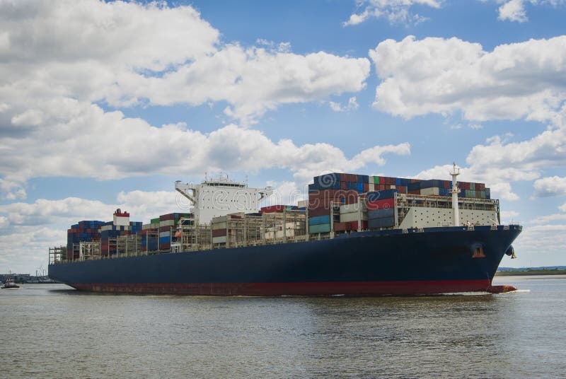 A Cargo Ship with Many Containers Floats Along the River on a Sunny Day ...