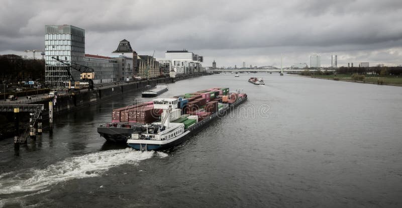 Cargo Ship Navigating through a River with Container Stacks on Board in ...