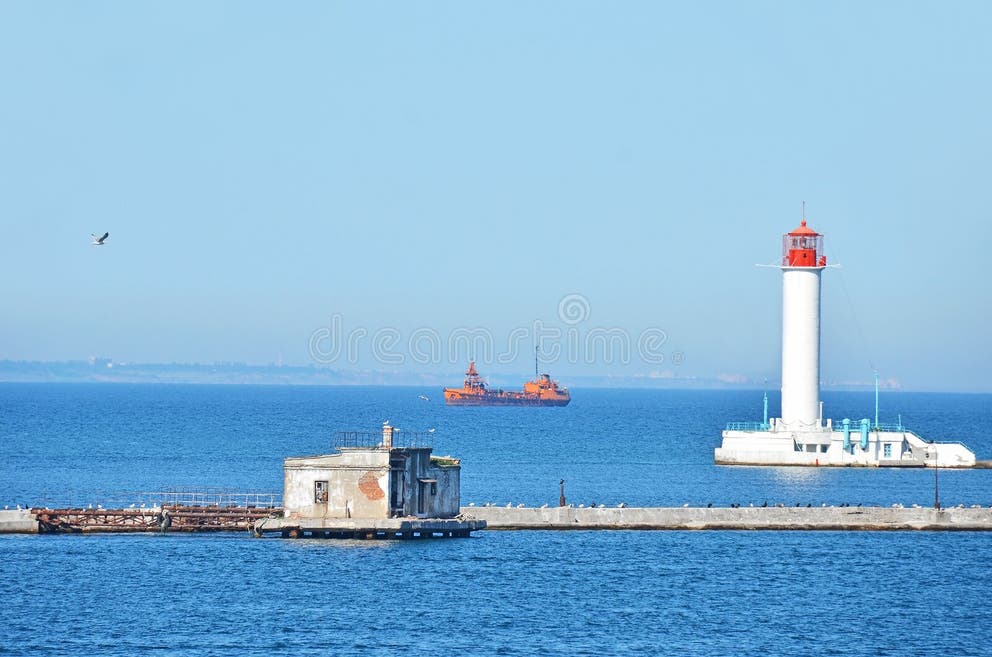 Cargo ship near lighthouse stock photo. Image of boating - 25397690
