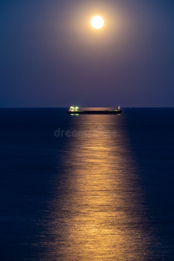 Cargo ship at night stock image. Image of industry, moon - 196936209