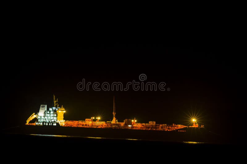 Cargo ship at night stock image. Image of shipload, landing - 34559559