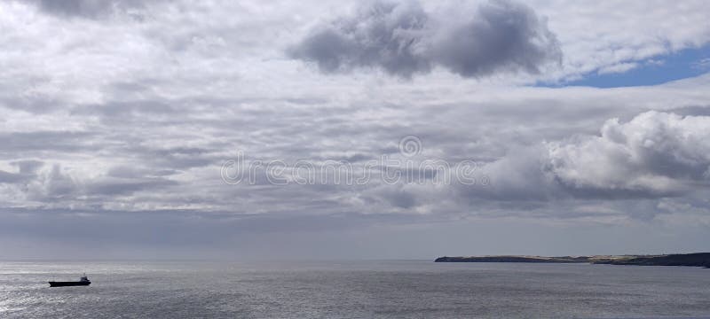 Cargo Ship in the Open Stormy Sea. with Heavy Rainy Sky Background ...