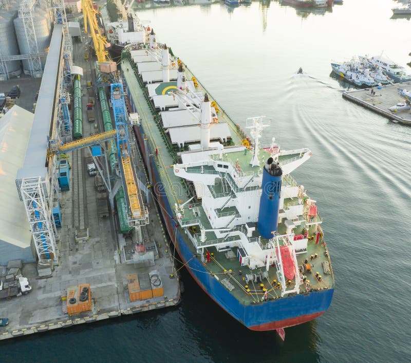 A Cargo Ship at the Pier in the Port. the Loading Process is in ...