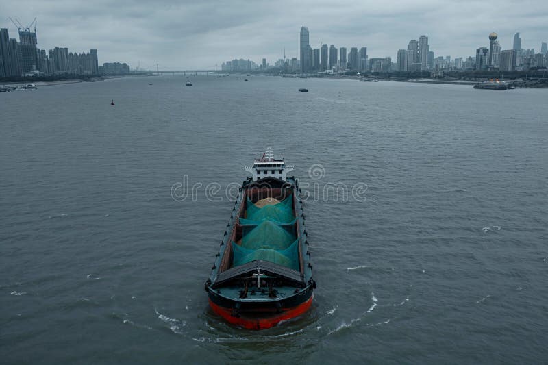 Cargo Ship on River with City Skyline. Stock Image - Image of marine ...