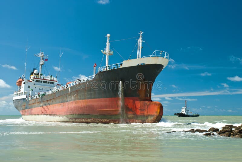 Cargo Ship Run Aground on Rocky Shore Stock Photo - Image of blue ...