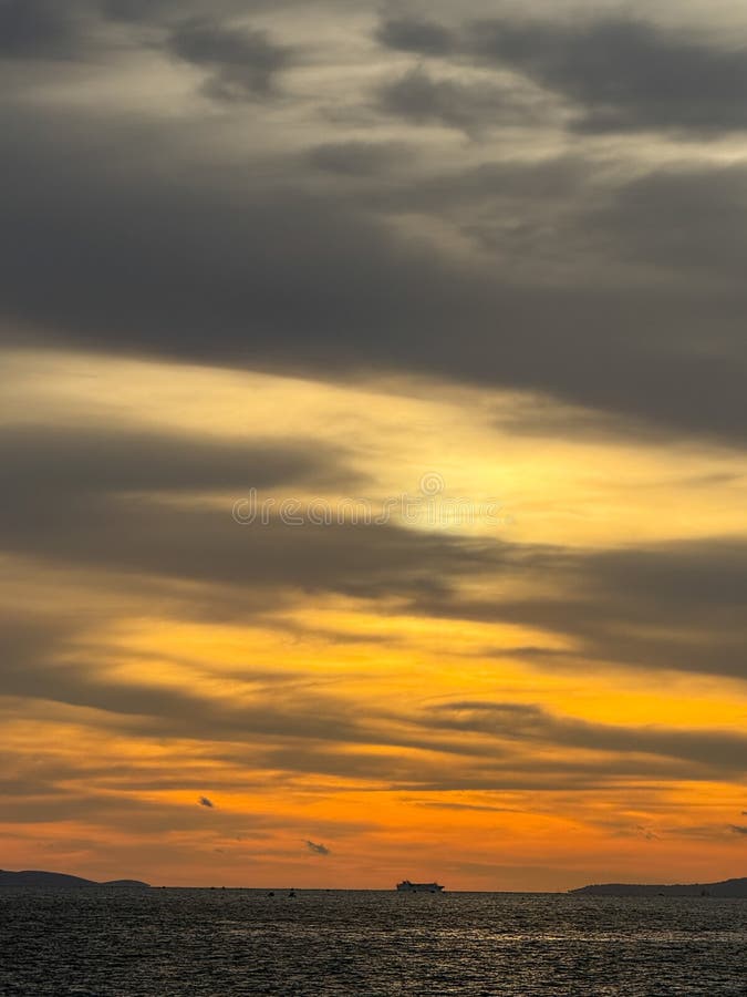 Cargo Ship Sailing at Sunset Under a Cloudy Sky Stock Photo - Image of ...