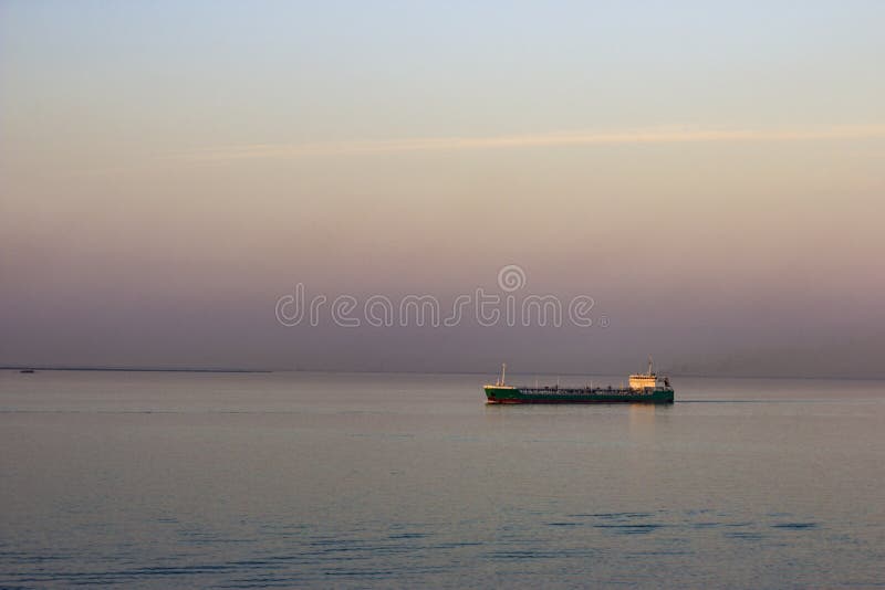 Cargo Ship on Sea in the Rays of the Setting Sun. Stock Photo - Image ...