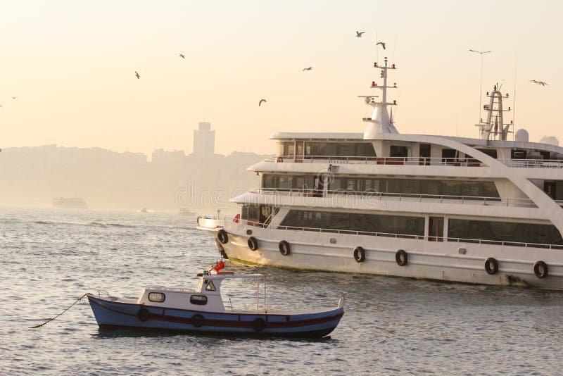 Cargo Ship with Small Boat on Sunset Time Stock Image - Image of boat ...
