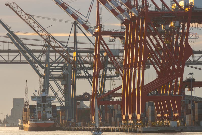 A Cargo Ship Stands in a Seaport with Huge Loading Cranes Stock Image ...