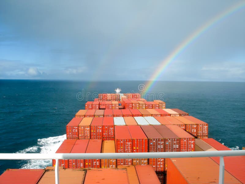 Cargo Ship with Transporting Containers Over the Ocean with Rainbow on ...