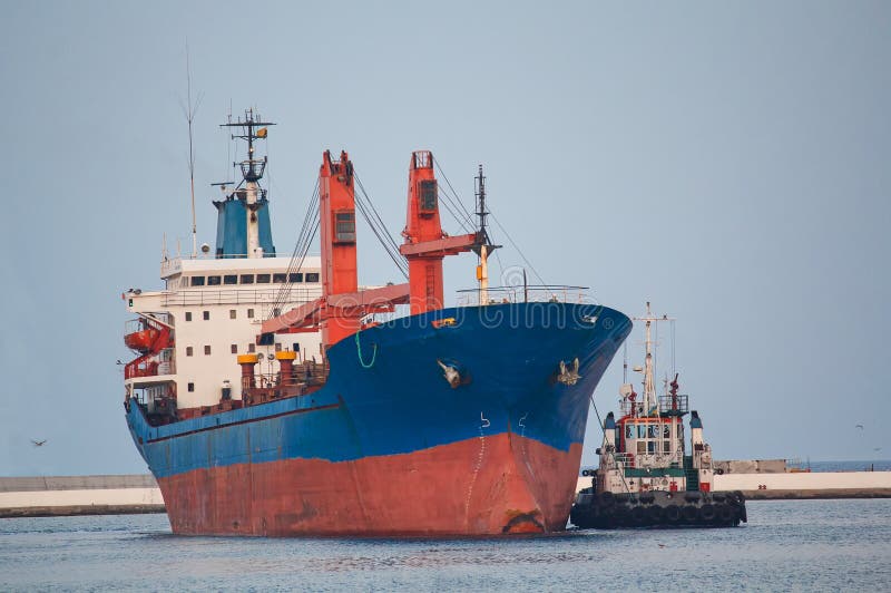 Cargo ship and tug boat stock image. Image of marine - 62903043