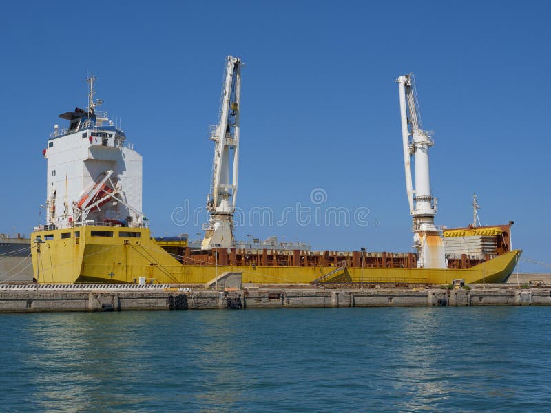 Cargo Ship Under Maintenance at a Shipyard with Two High Cranes Stock ...