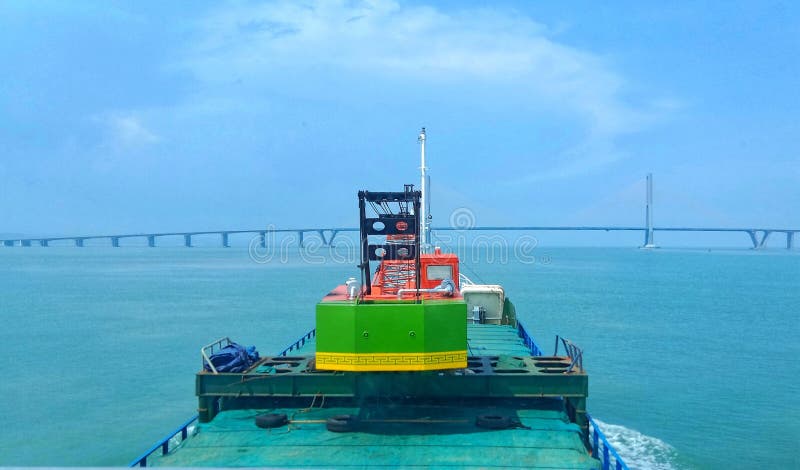 A Cargo Ship that Will Pass Under the Bridge in the Strait Stock Image ...