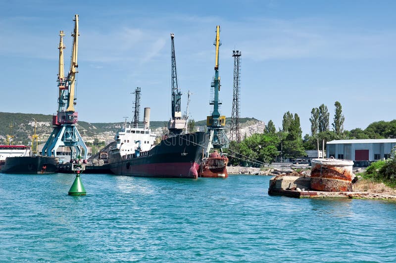 Cargo Ships Docked for Loading in Old Harbor. the Rusty Buoy Close-up ...