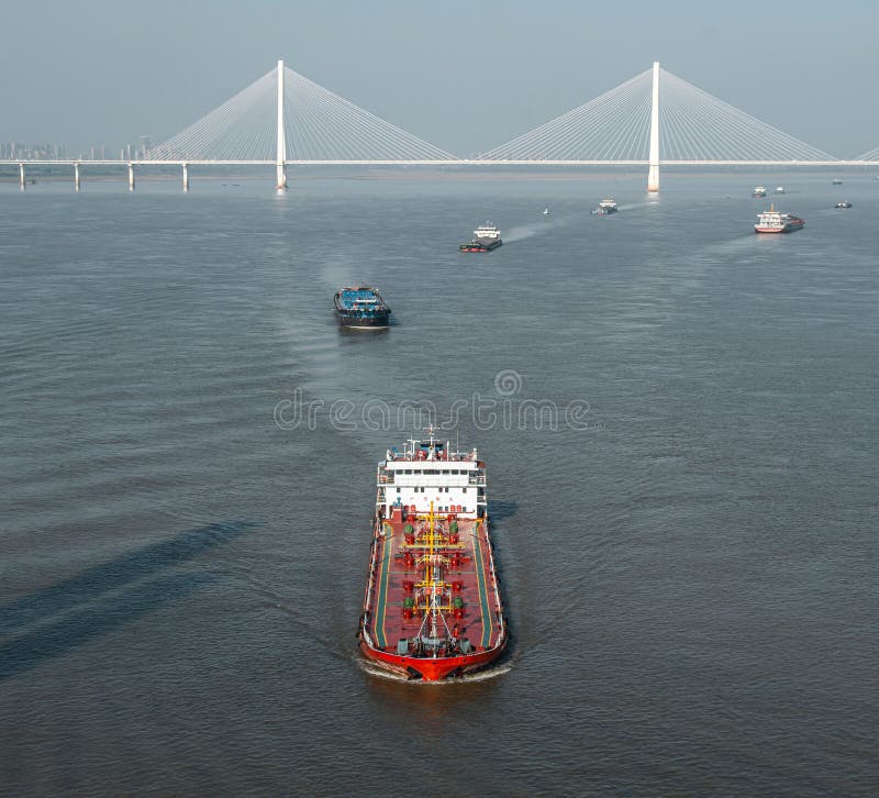 Cargo Ships Under a Cable-stayed Bridge Stock Image - Image of ...