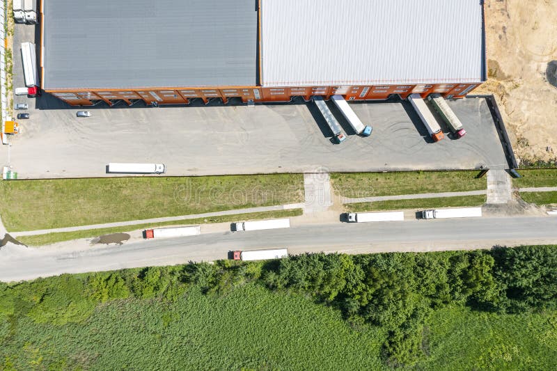 Cargo Trailers Unloading Merchandise in Logistics Center. Aerial View ...