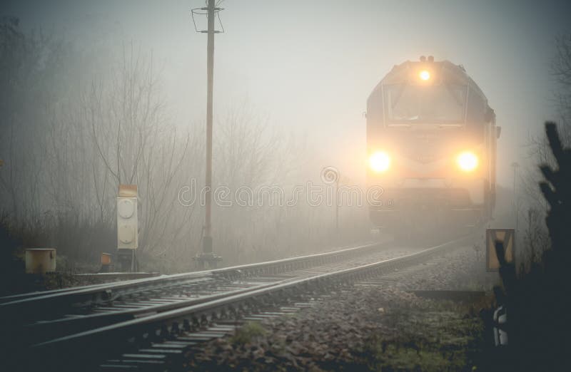 Freight Train Approaching Industrial Railroad Tracks Stock Photos ...