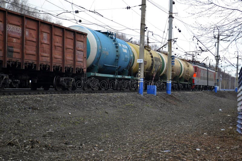 The Cargo Train with Tanks Moves on Railway Tracks. Editorial Photo ...
