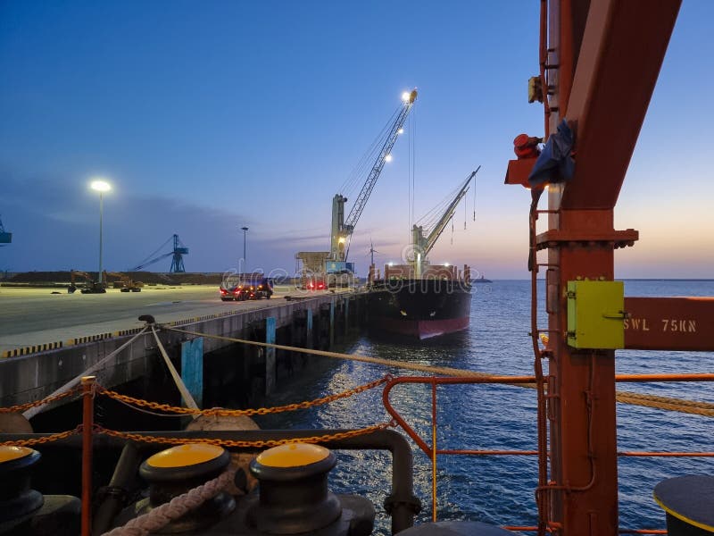 Cargo Vessel Docking at Sunset, Loading Containers Using Crane ...