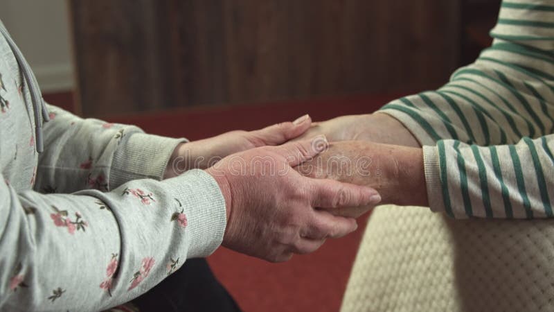 A Caring Handshake. the Hands of One Woman are in the Hands of Another ...