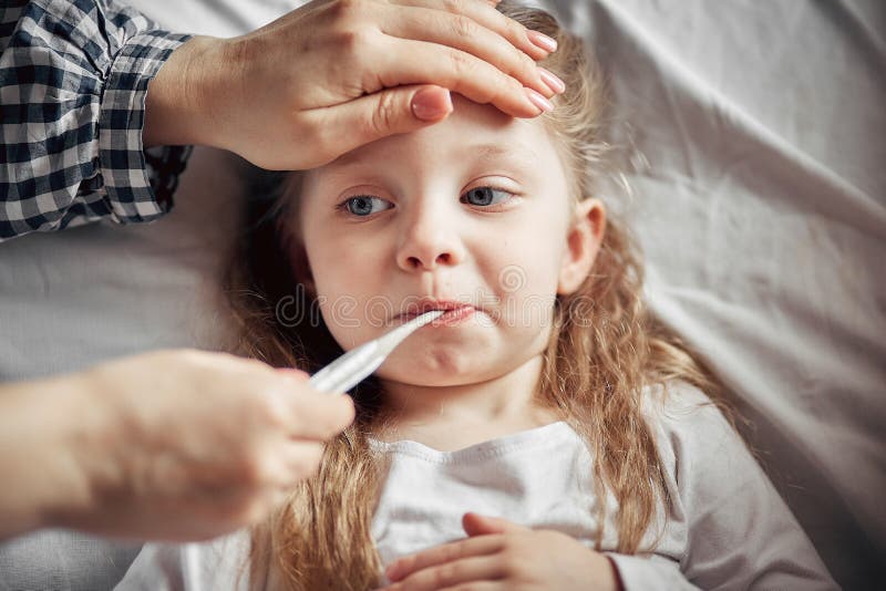 Caring Mother Measures the Temperature of a Sick Little Girl. Stock ...