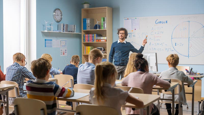 Caring Teacher Explains Lesson To a Classroom Full of Bright Diverse ...