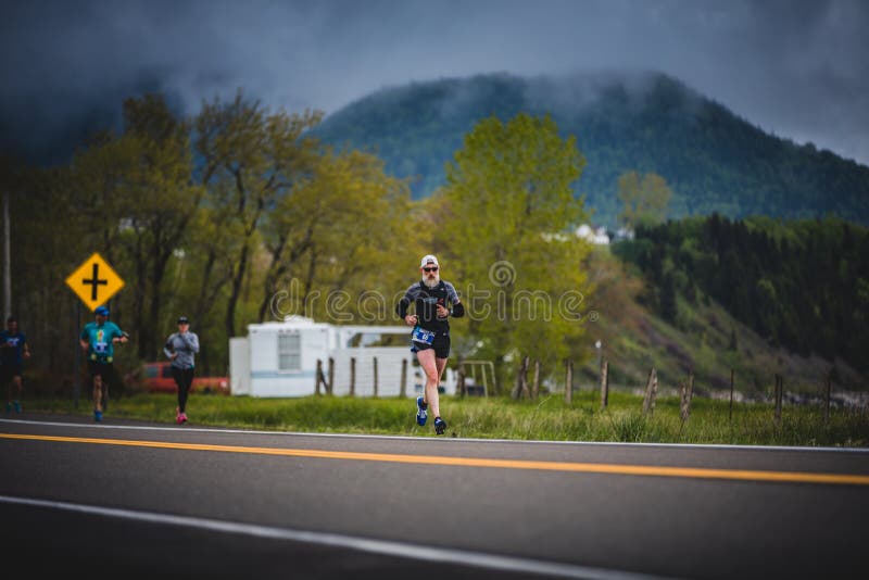 Senior Man Running Alone during the Marathon with Beautiful Ocean ...
