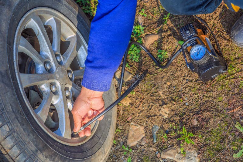 Pumping a Car Wheel with a Compressor Stock Photo - Image of adventure ...