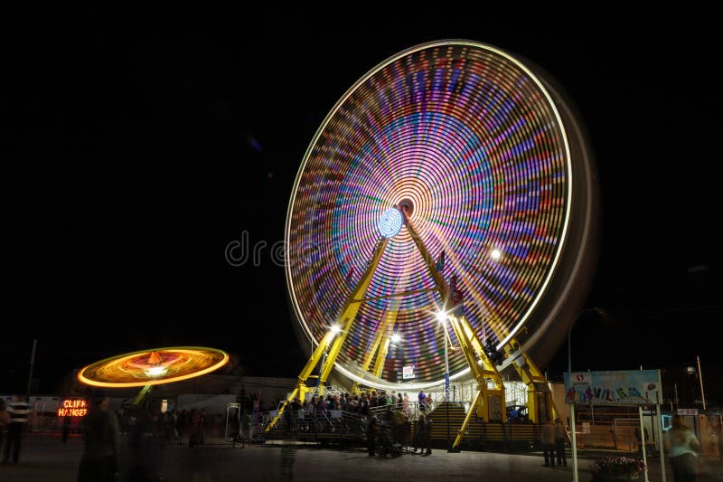 A Carnival Ride with a Spinning Wheel and a Carousel Stock Photo ...