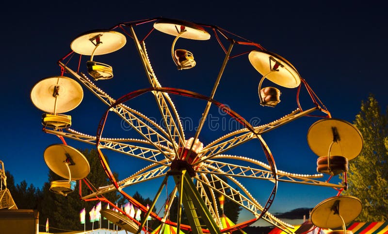 Carnival Sunset Umbrella Ride Stock Photo - Image of tents, yellow ...