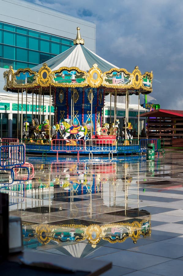 Carousel on a Cloudy Day with Reflection Stock Image - Image of ...