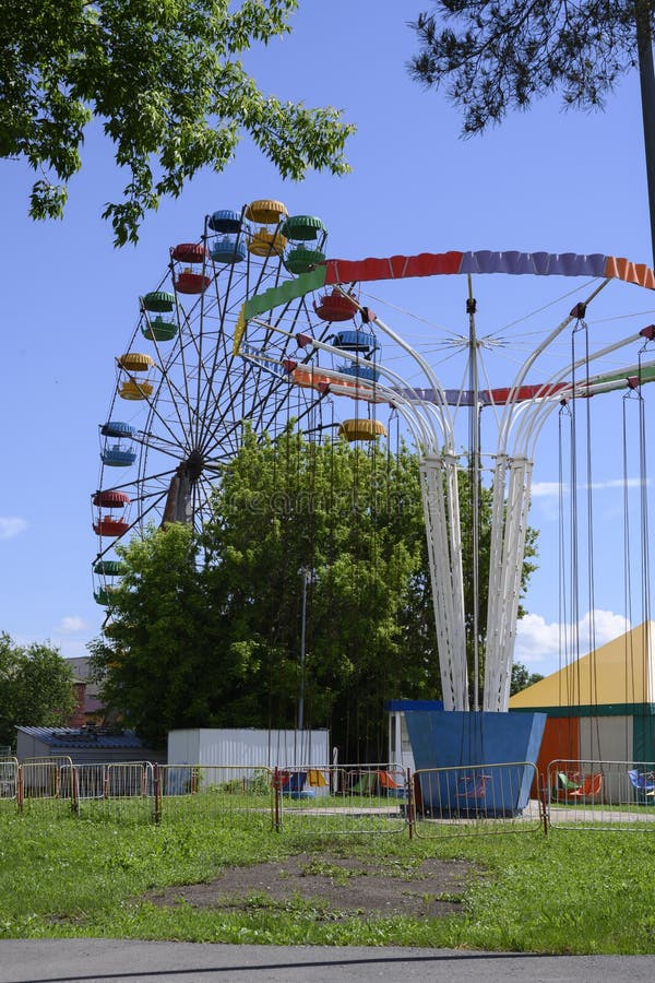 The Carousel and Ferris Wheel in the Park in Summer Stock Photo - Image ...