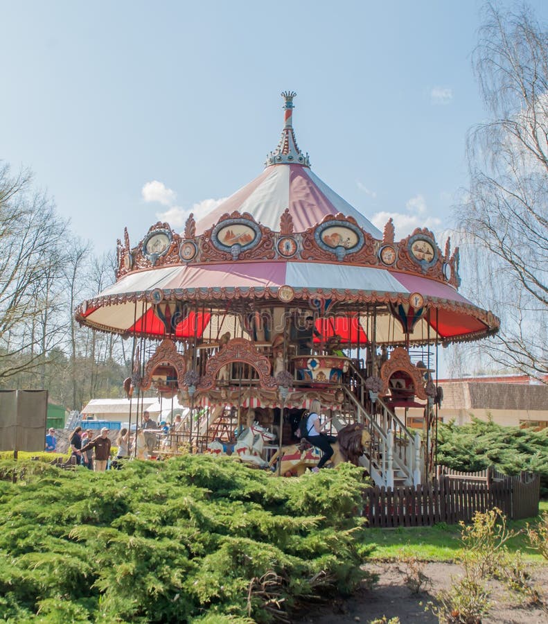 Carousel and People on it in the Amusement Park Editorial Stock Photo ...