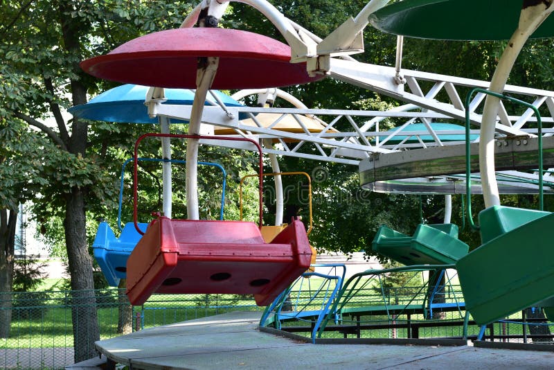 Carousel Working in a City Park with Grayings of Different Colors, Shot ...