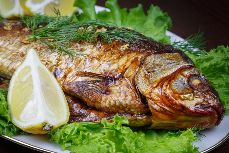 Carp Cooked in the Oven with Potatoes and Lemon Stock Photo - Image of ...